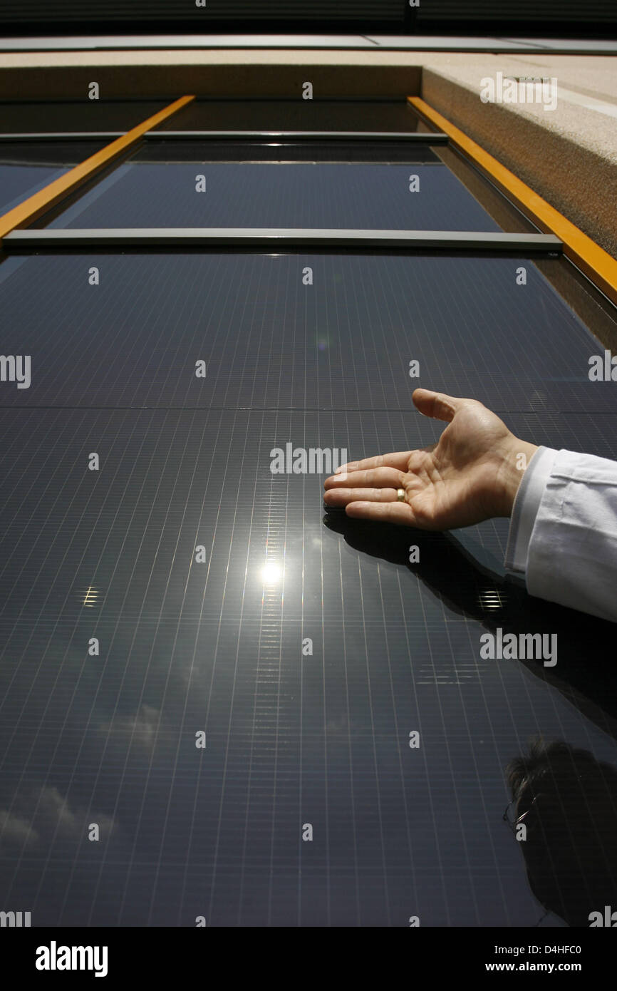An employee of solar module producer Schott Solar points at the cell ...