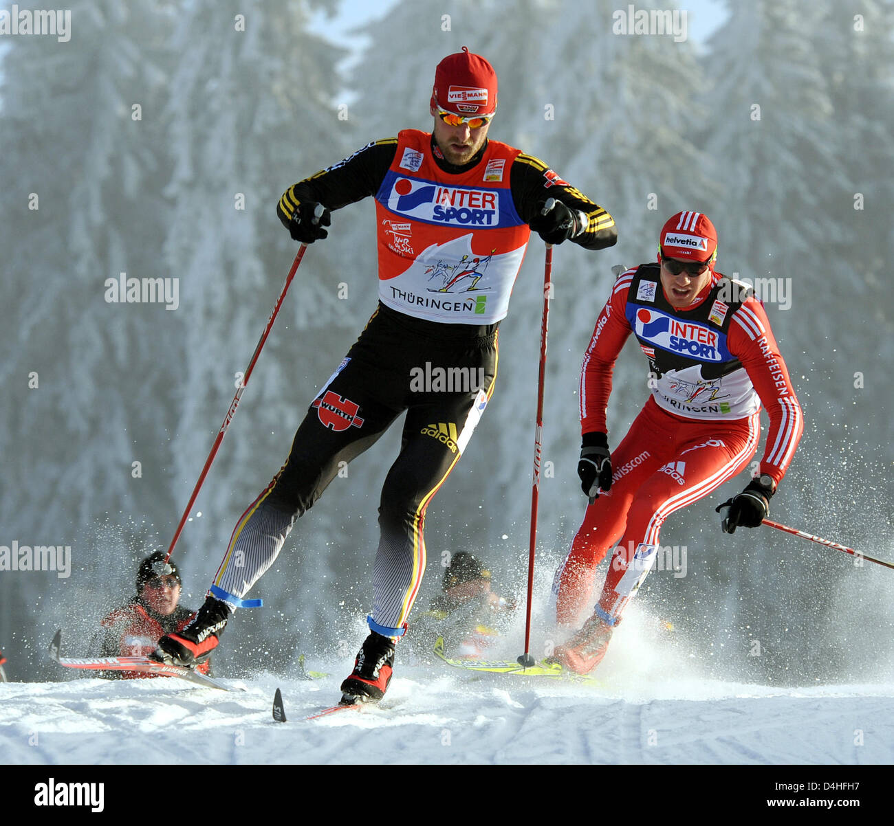 Second placed German cross country skier Axel Teichmann (L) followed by ...
