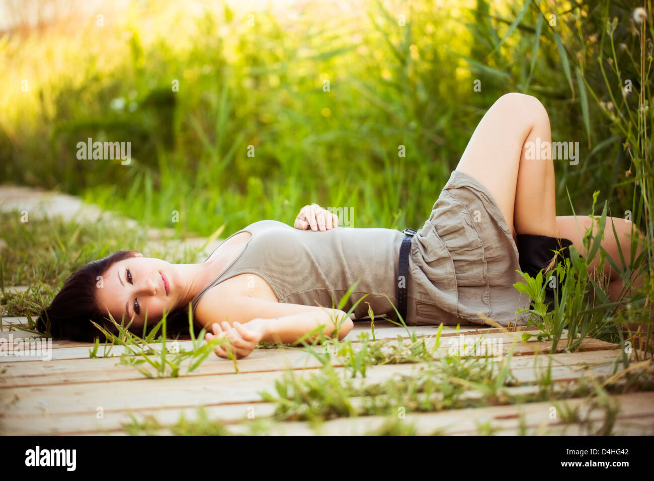 Young beautiful girl lying in nature Stock Photo - Alamy
