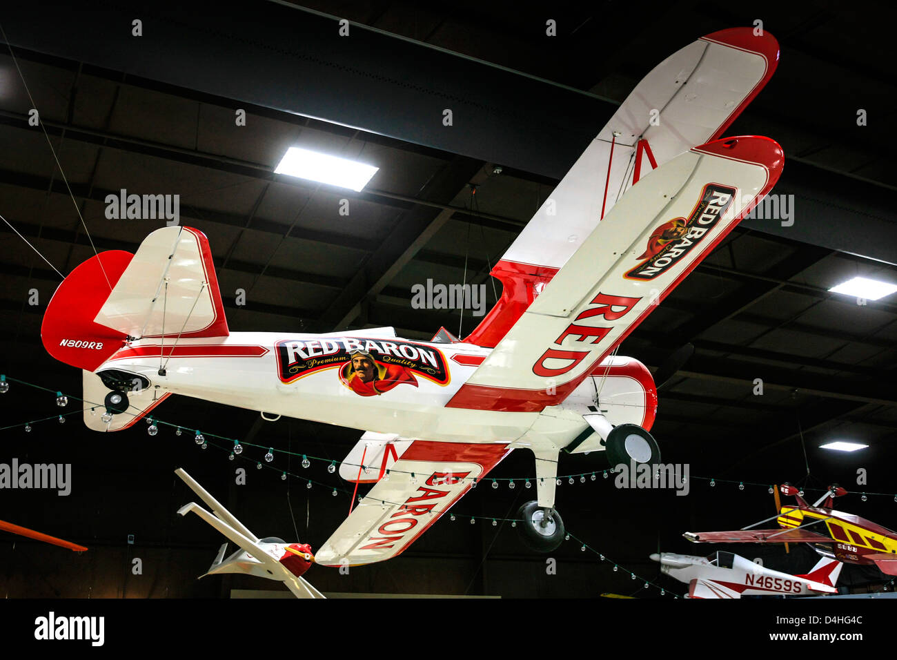 A Red Baron Stearman hands above other exhibits inside the Sun n Fun ...