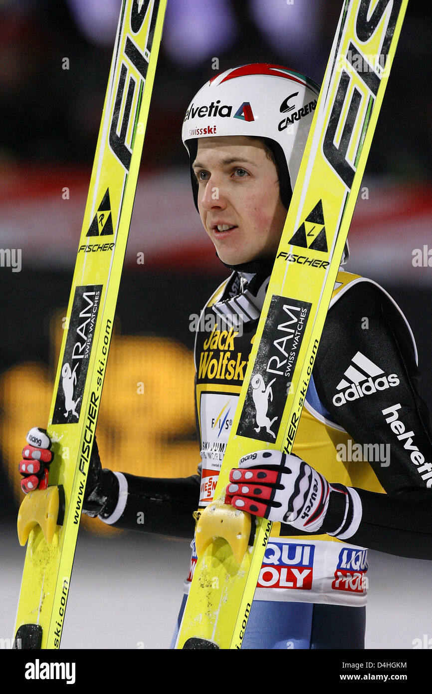 Swiss ski jumper Simon Ammann watches the score board after his jump ...