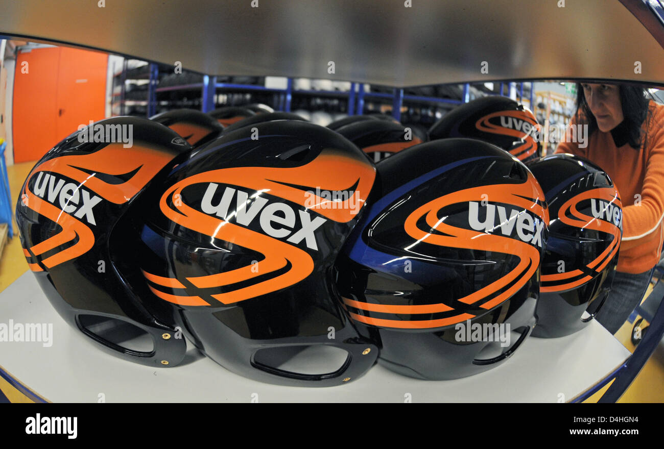 A woman works at a factory of ski hard hat manufacturer uvex in ...