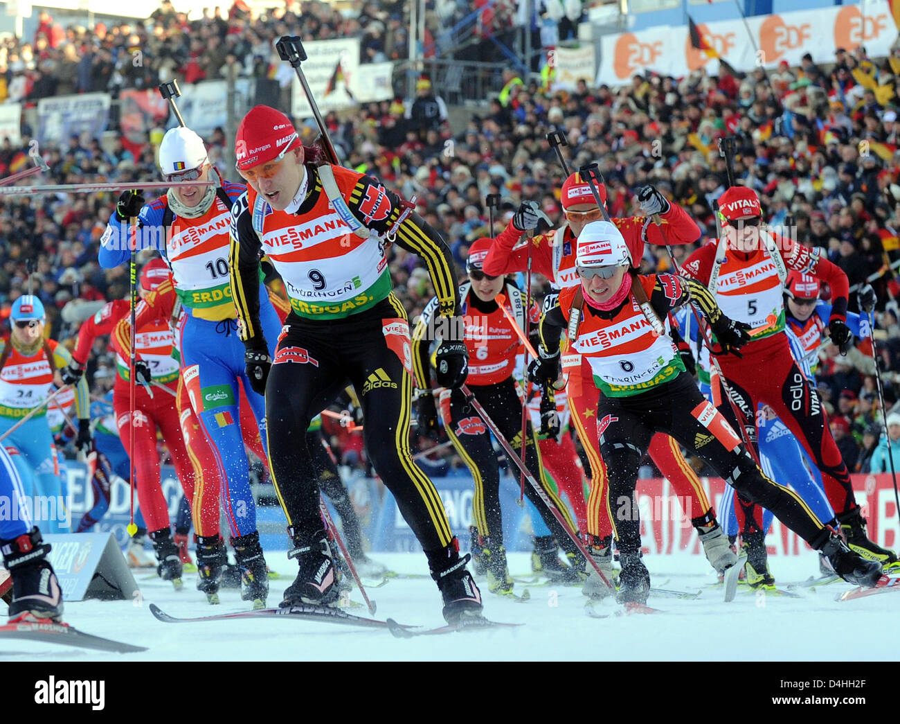 Biathletes are shown in action during hte 12.5 kilometres mass start ...