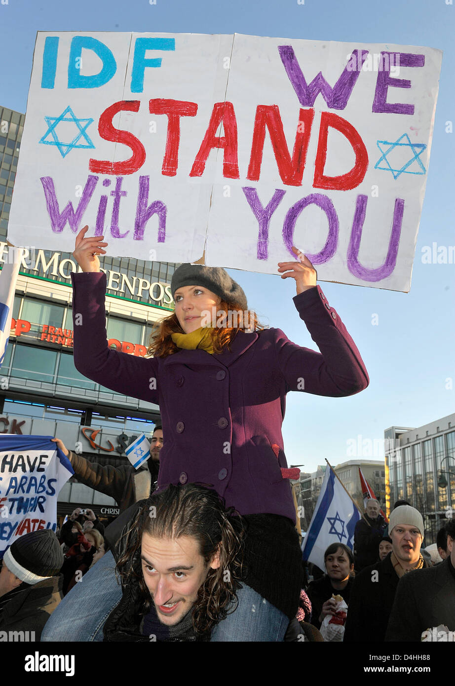 A woman holds up a banner that reads ?IDF - We stand with you? during a ...
