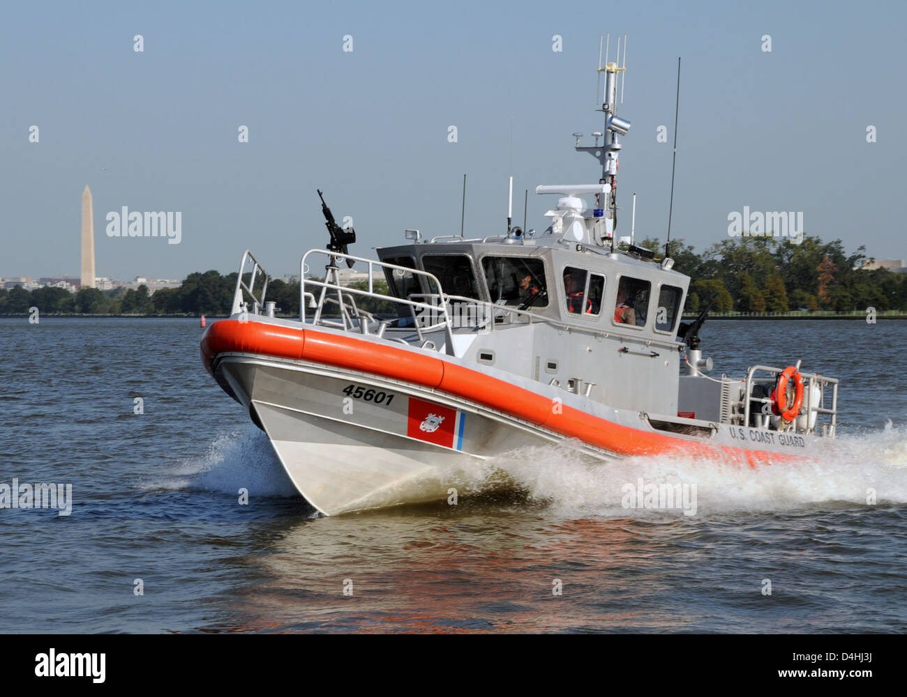 A Coast Guard cutter participates in maritime operations with boats and ...