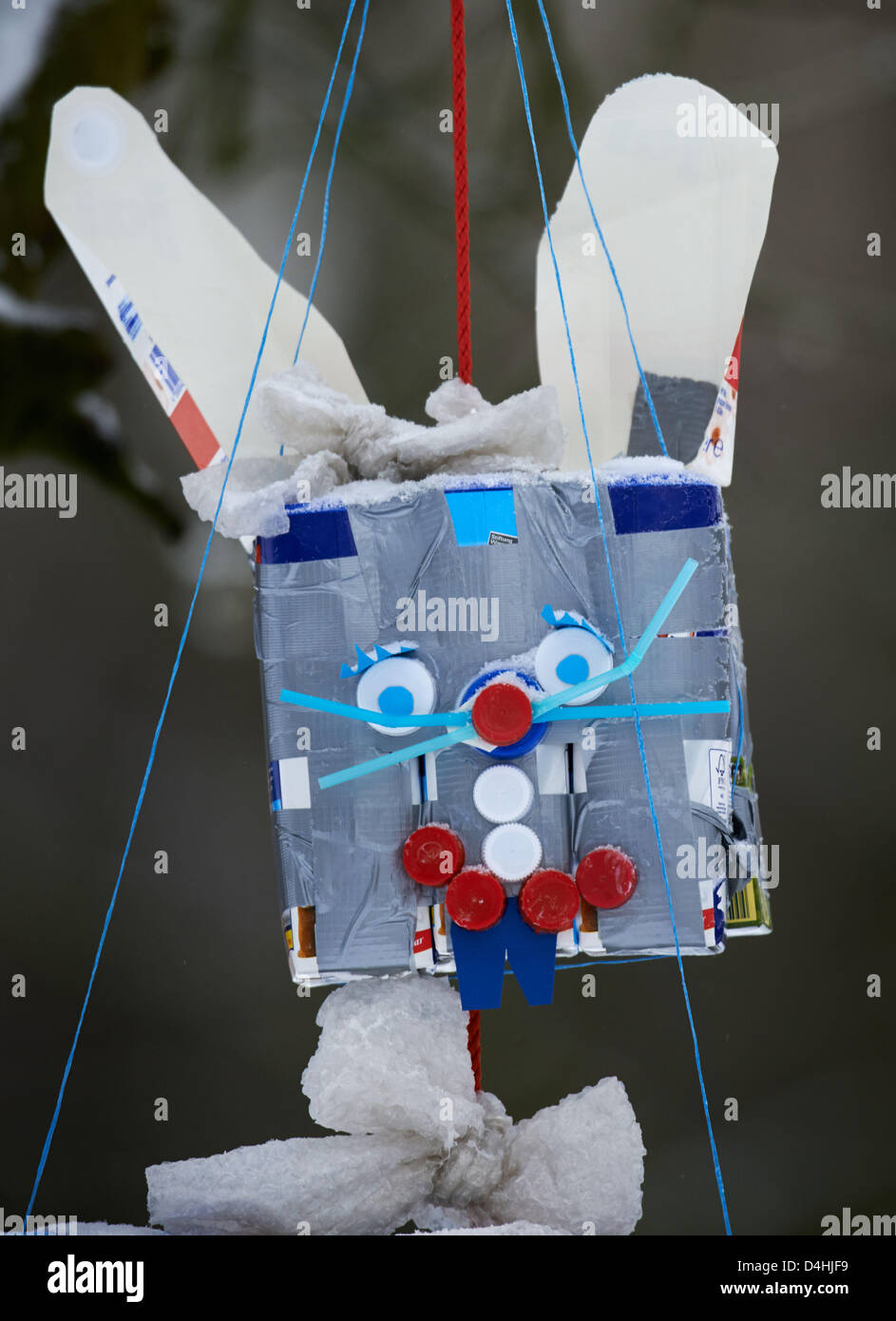 A rabbit marionette made mainly from packing trash hands in a snow ...