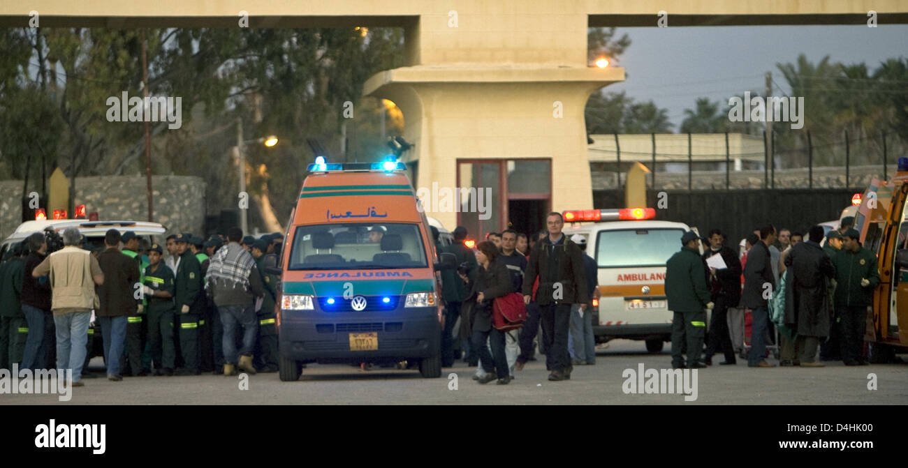 Ambulance cars stand at an Egyptian border crossing and transport ...