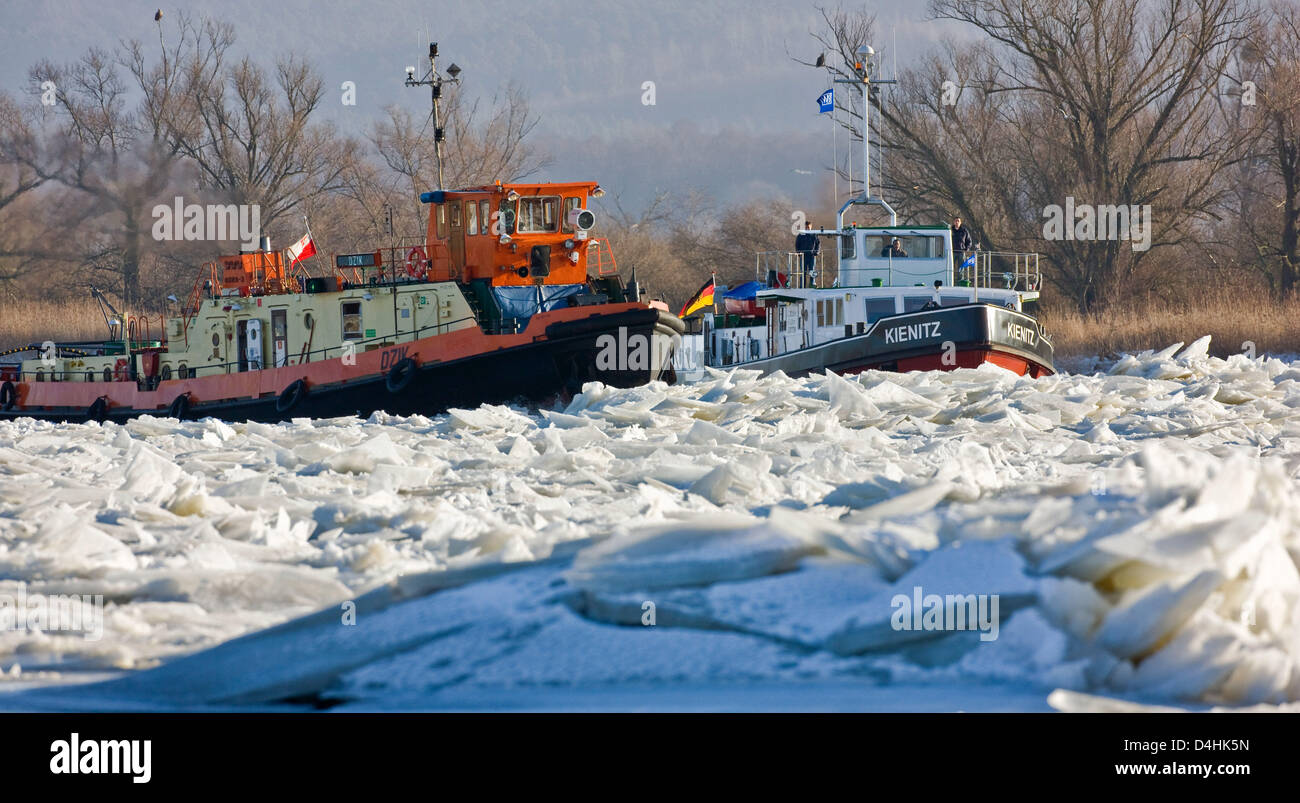 A Polish (L) and a German ice breaker clear a shipping lane from sheets ...