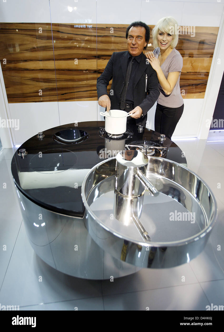 Model Anika and an employee of kitchen maker Maronese, Italy pose next ...