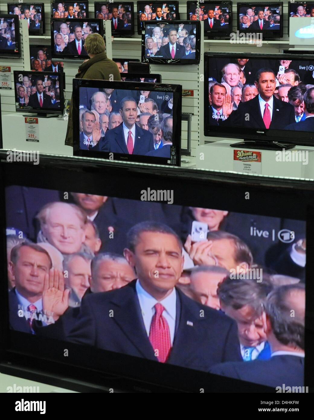 Arrays of tv screens show the swearing-in ceremony of US President ...