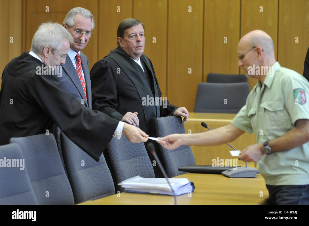 Defendant Klaus Zumwinkel (C), former CEO of Deutsche Post AG, and his ...