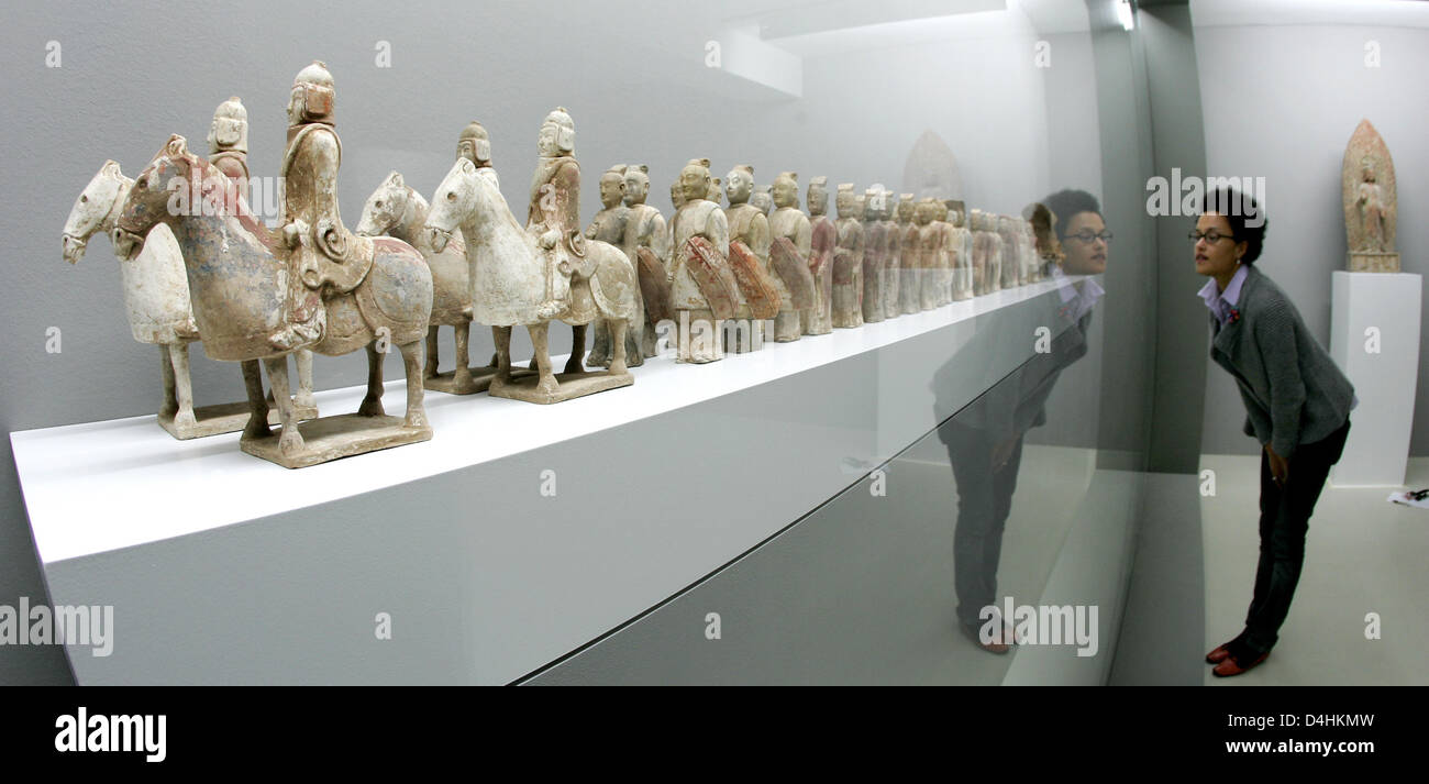 A visitor looks at Chinese burial objects on display at DKM Museum in ...