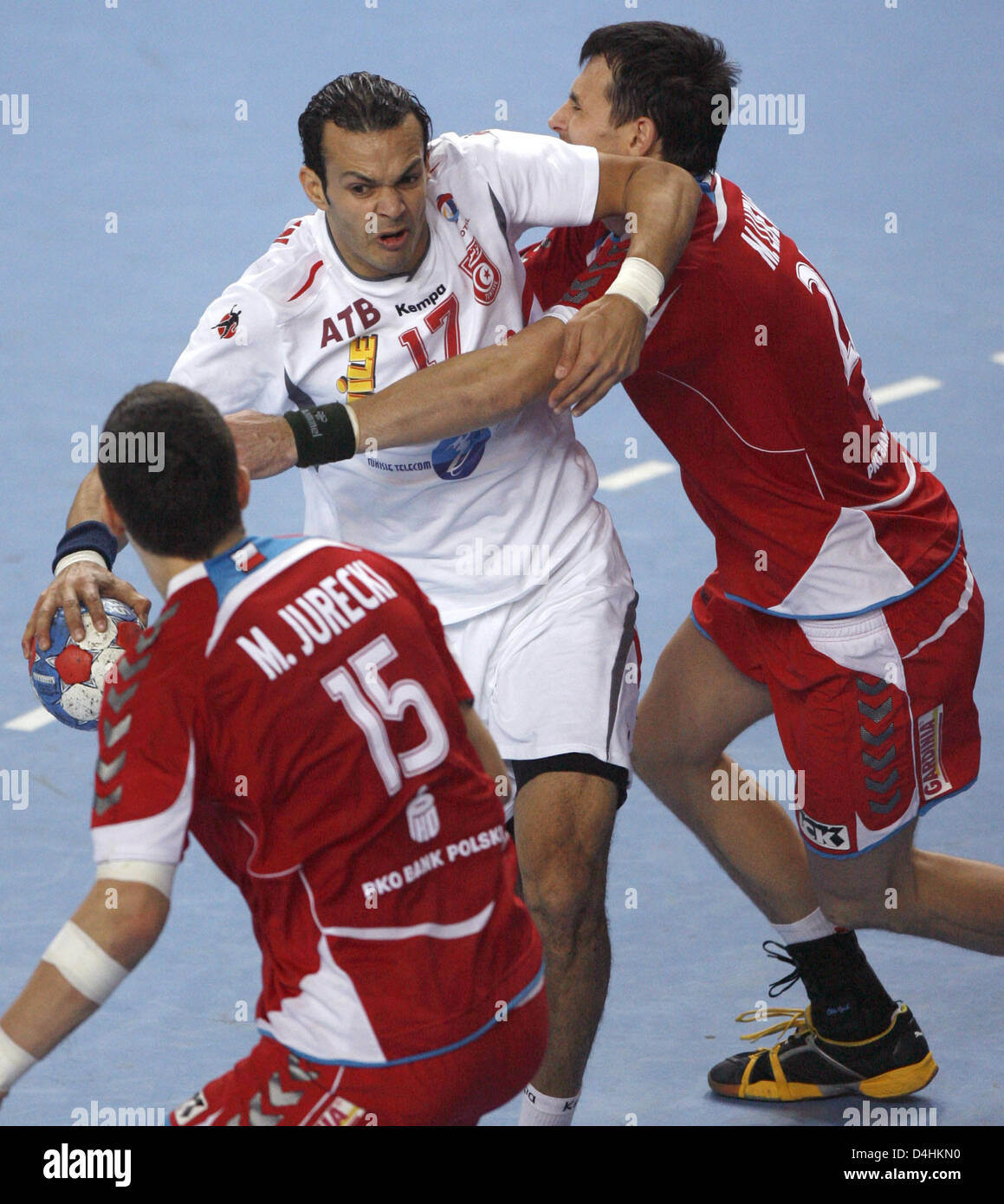 Tunesian Walid Ben Amor (C) and Michal Jurecki (L) and Marcin Lijewski of Poland seen in action ...