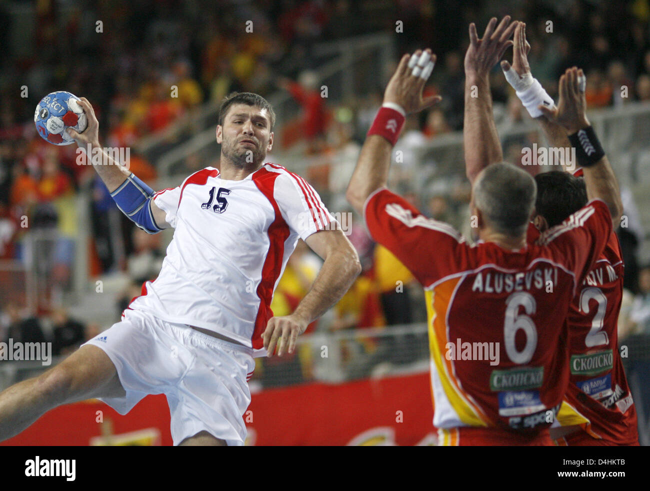 Russia?s Alexey Rastvorzev (L) tries to throw the ball past Macedonia?s ...