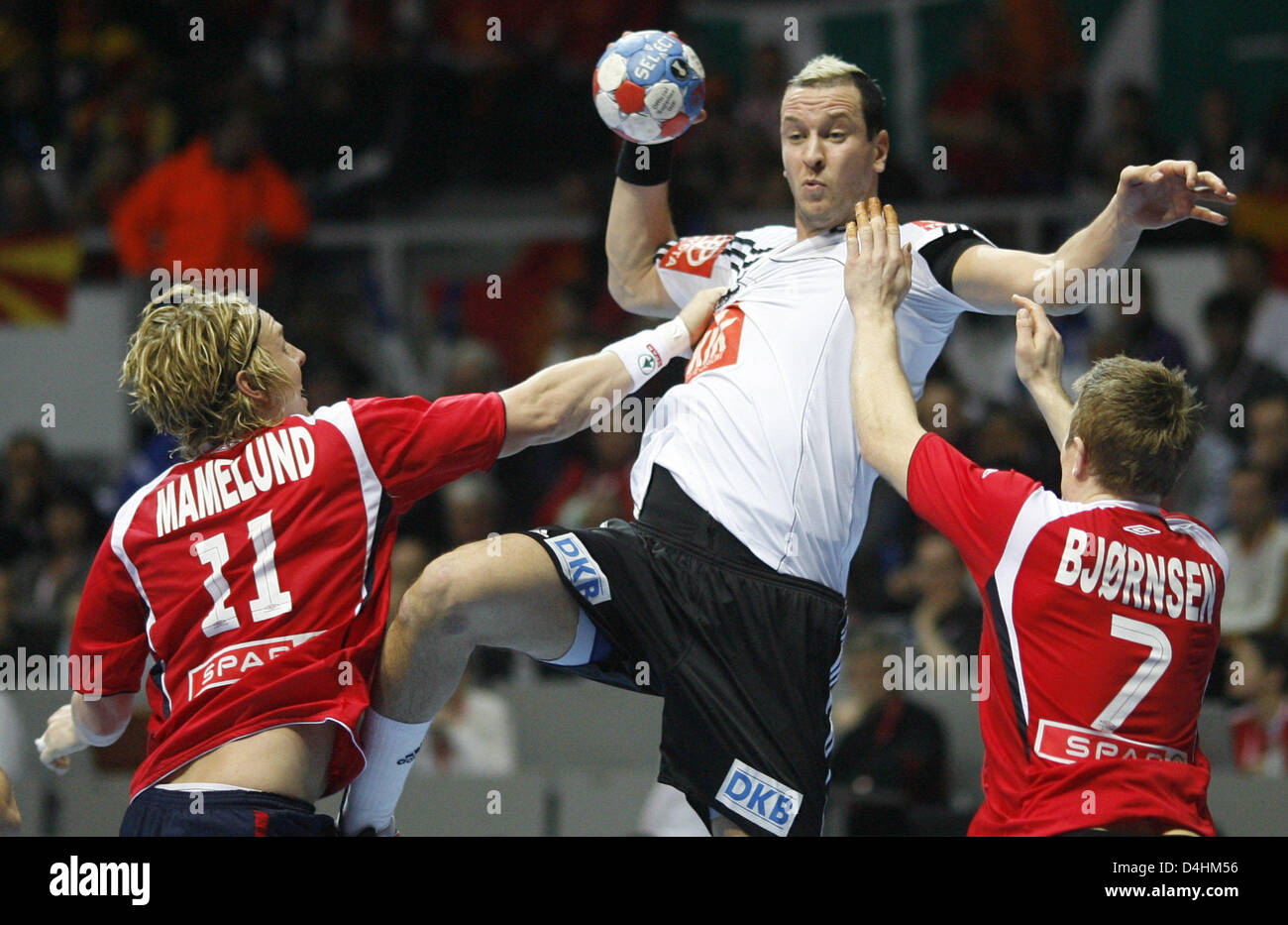Germany?s Pascal Hens (C) tries to throw past Norway?s Erlend Mamelung ...