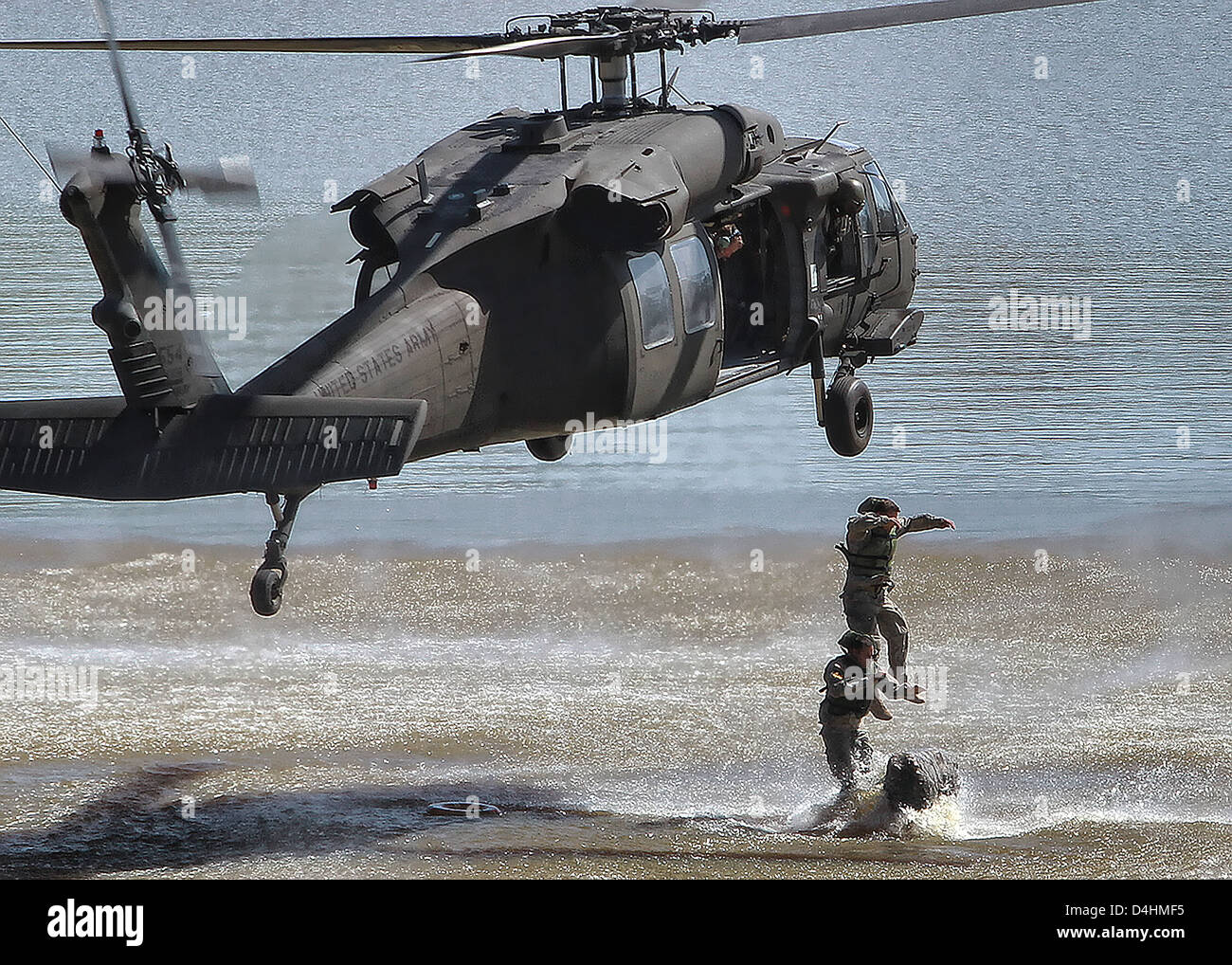 US Army Rangers leap into the water from a Black Hawk helicopter during ...