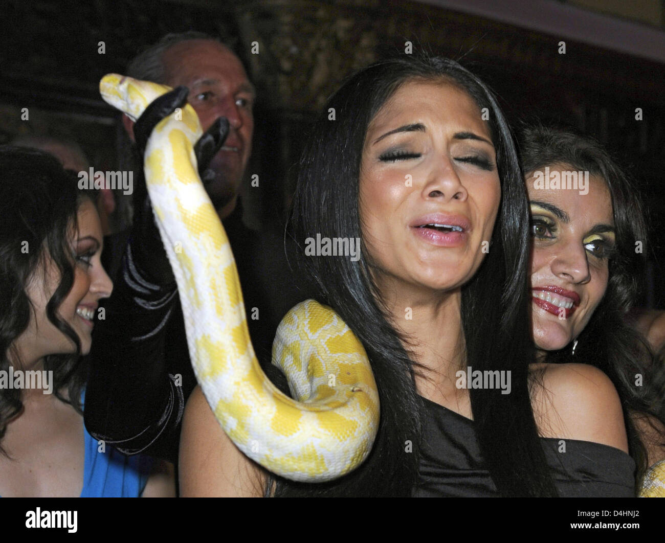 US singer Nicole Scherzinger poses with a snake at the ?Lambertz Monday ...