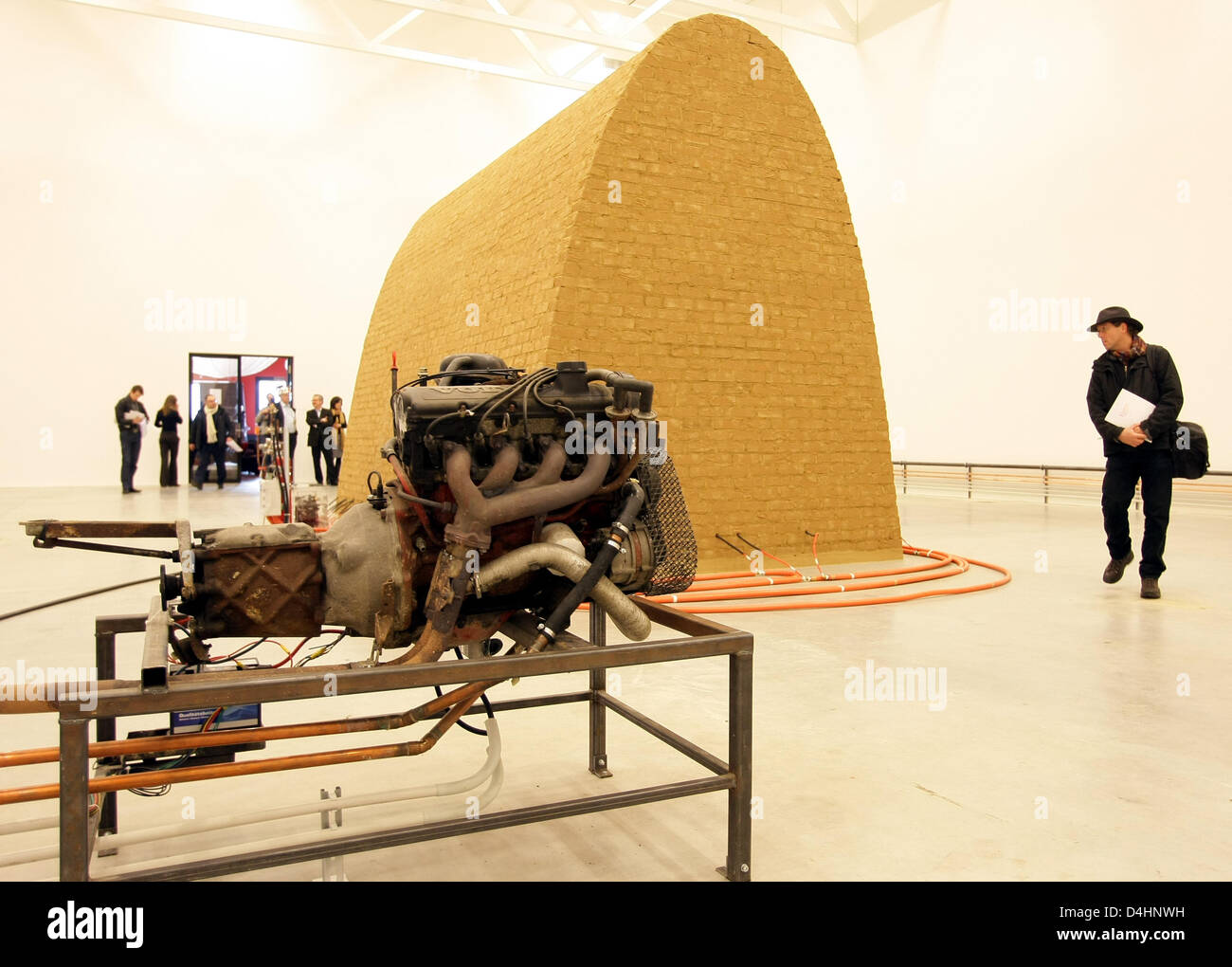 A visitor eyes the mud brick installation ?Under Lime? of British ...