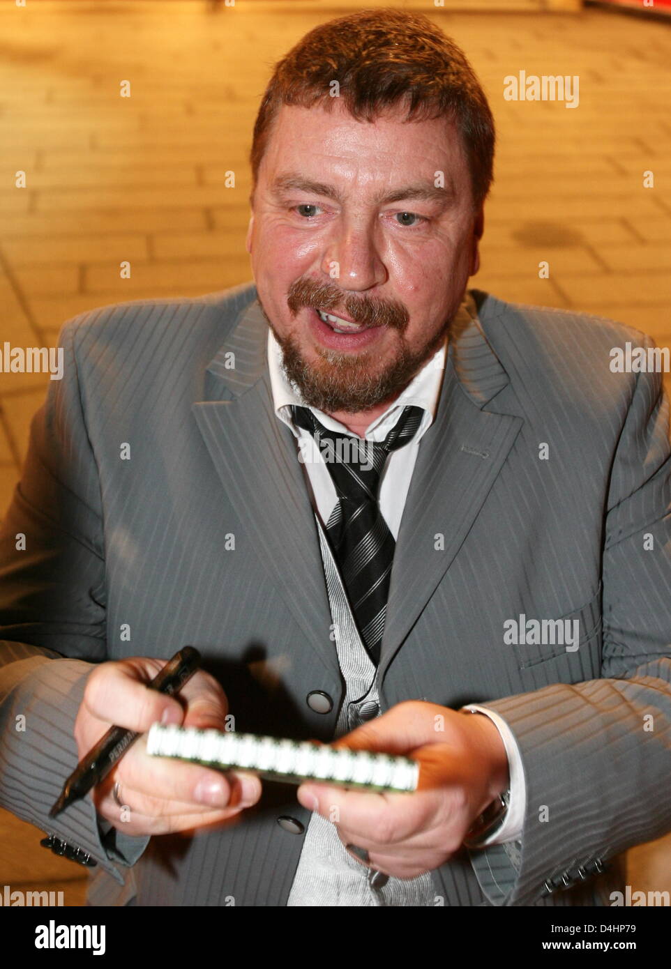 German actor Armin Rohde writes autographs as he arrives at the ...