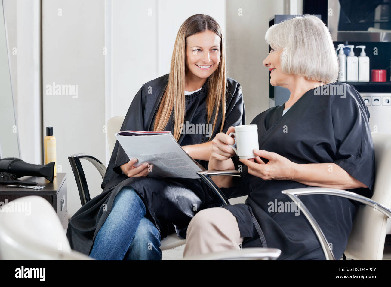 Female Client's Conversing At Beauty Parlor Stock Photo - Alamy