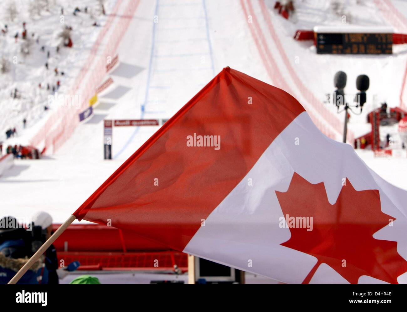 A Canadian flag is waved in the finish area during the Men?s Downhill ...