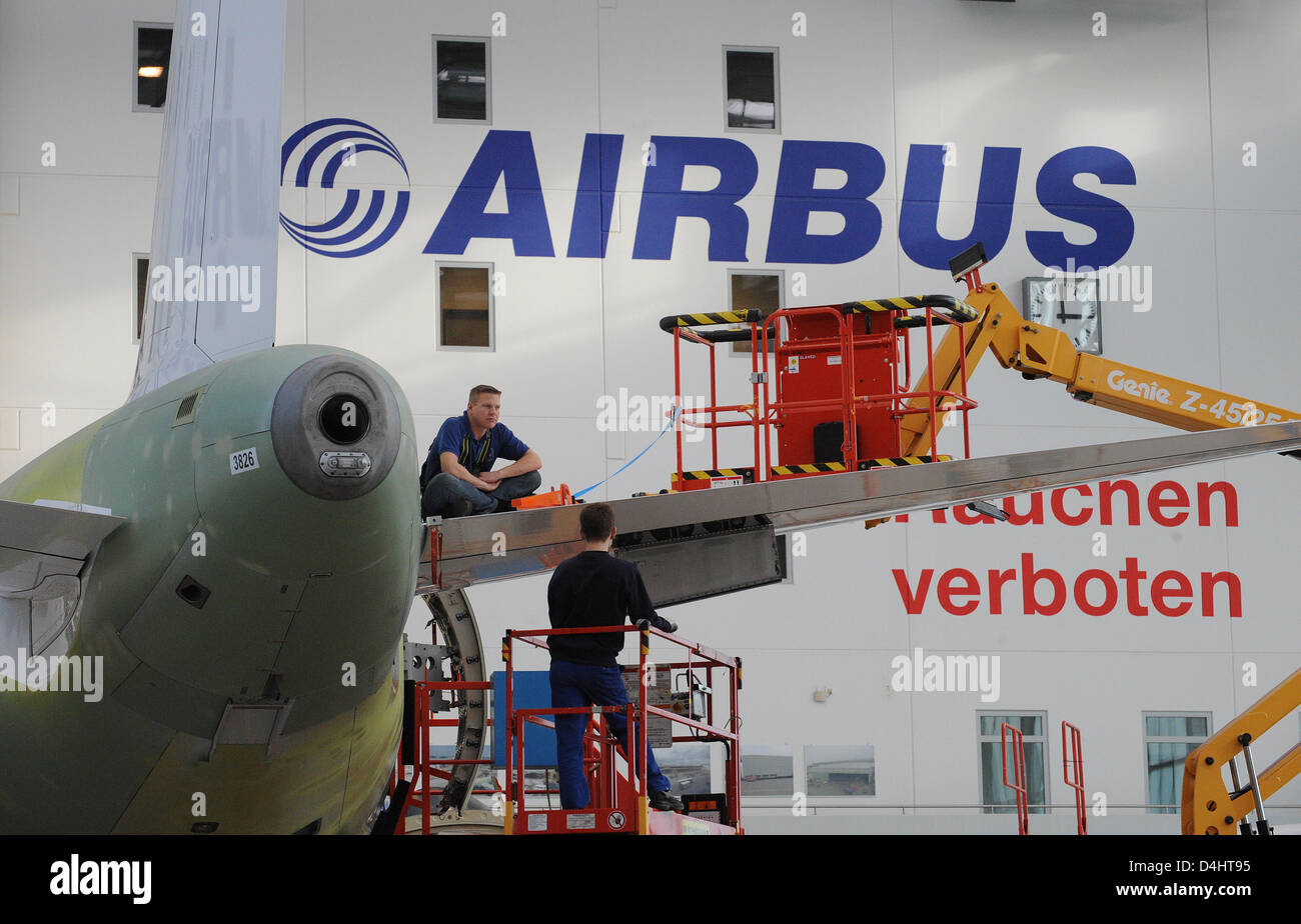 Members of staff of Airbus work at the final assembly of an Airbus A320 ...