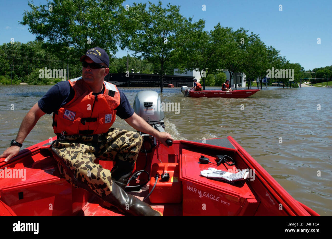 A Coast Guard operation featuring military personnel and boats deployed ...