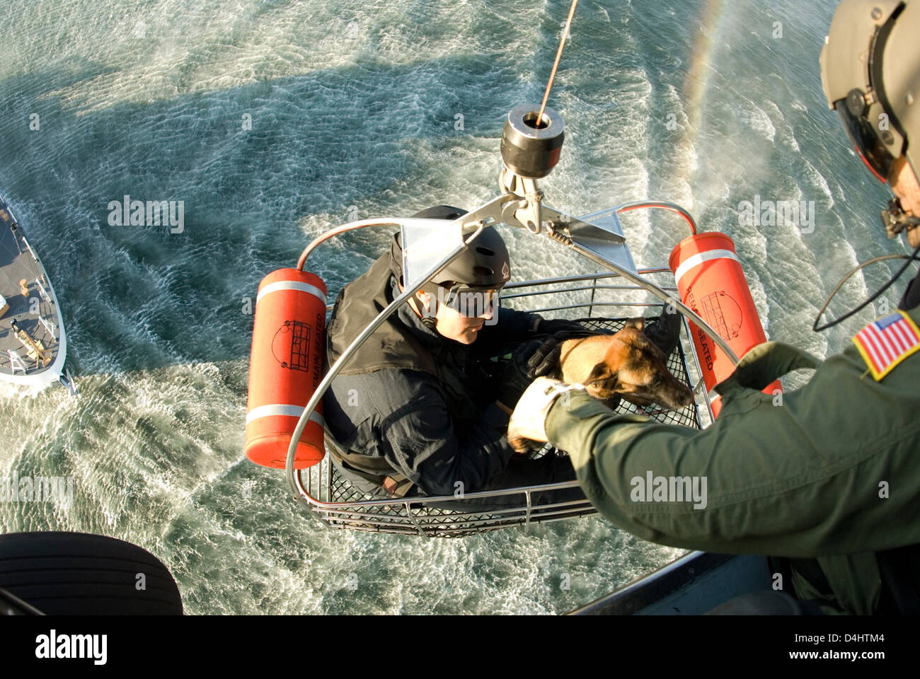 A U.S. Coast Guard K9 team member works with their handler during a ...