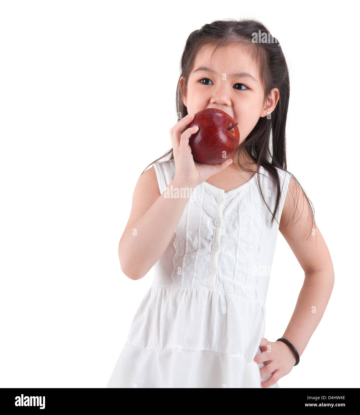 Little Asian child eating an apple on white background Stock Photo - Alamy