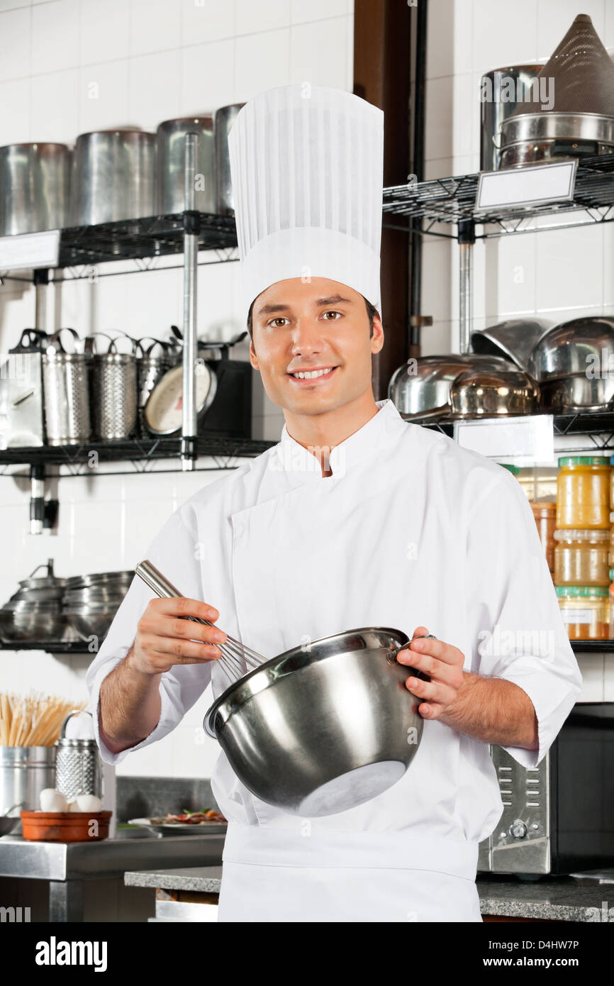Young Chef With Wire Whisk And Mixing Bowl Stock Photo - Alamy