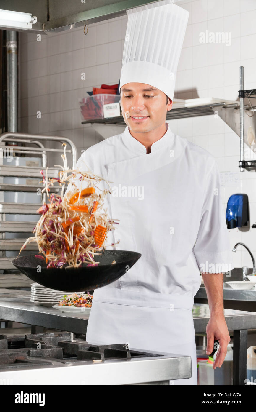 Chef Tossing Vegetables in Wok Stock Photo - Alamy
