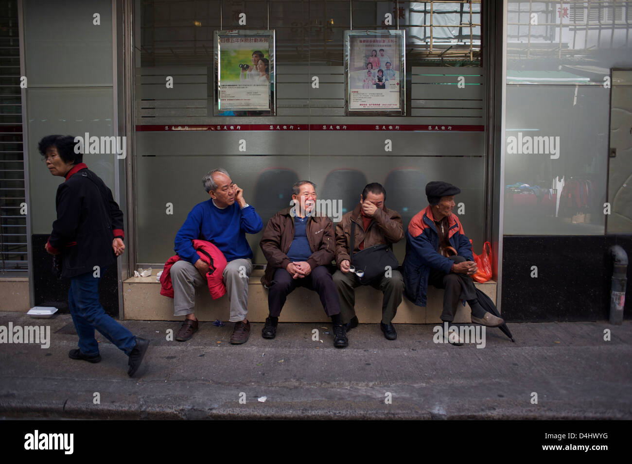 sitting in front of the bank Stock Photo - Alamy