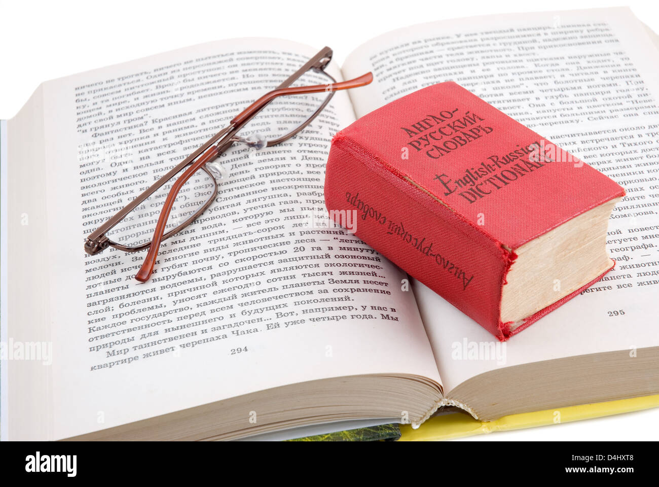 The small red dictionary lays on the opened book Stock Photo - Alamy