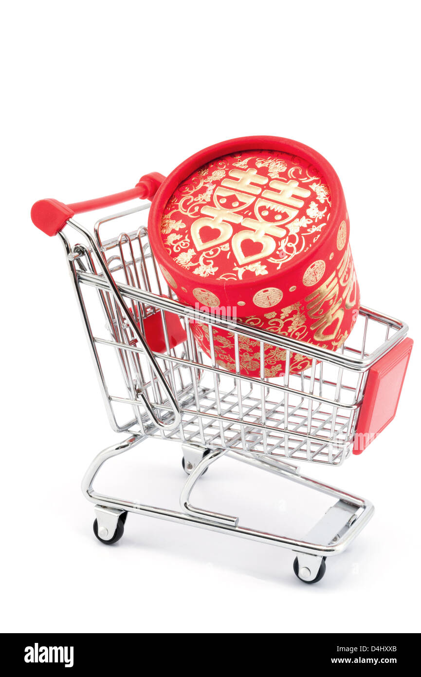 Cylinder gift box in shopping cart on white background Stock Photo - Alamy