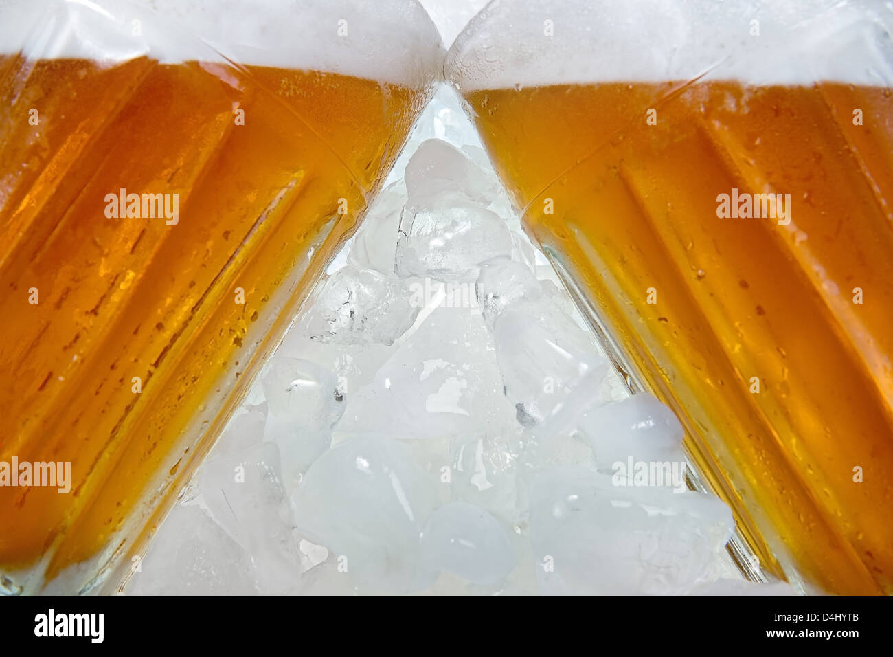 Glass of cold beer lying in the ice Stock Photo - Alamy