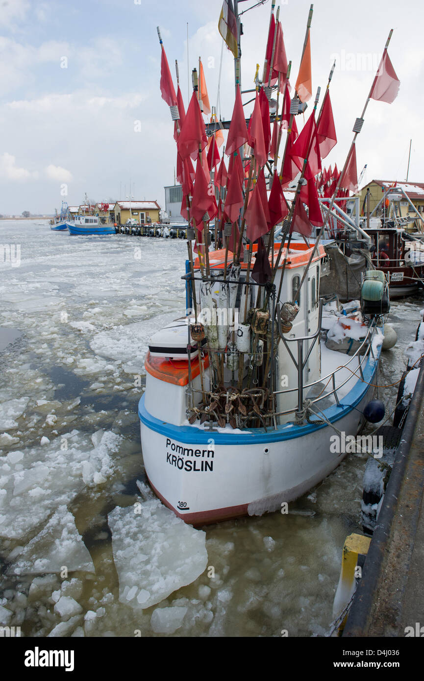 Fishing boats are frozen in the dense ice in the port of Freest ...