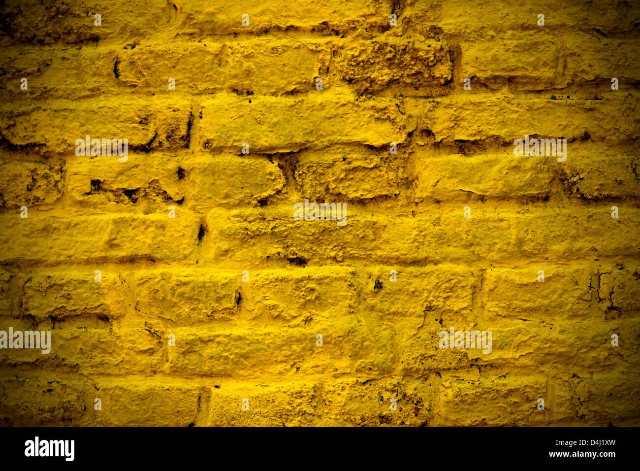 A yellow brick wall for background or texture usage Stock Photo - Alamy