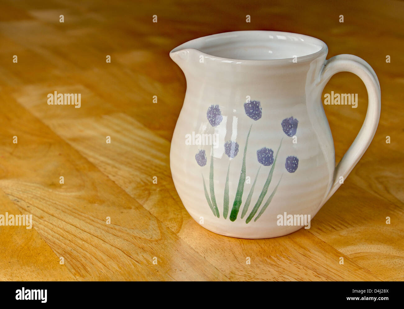 pottery jug on wooden table Stock Photo - Alamy