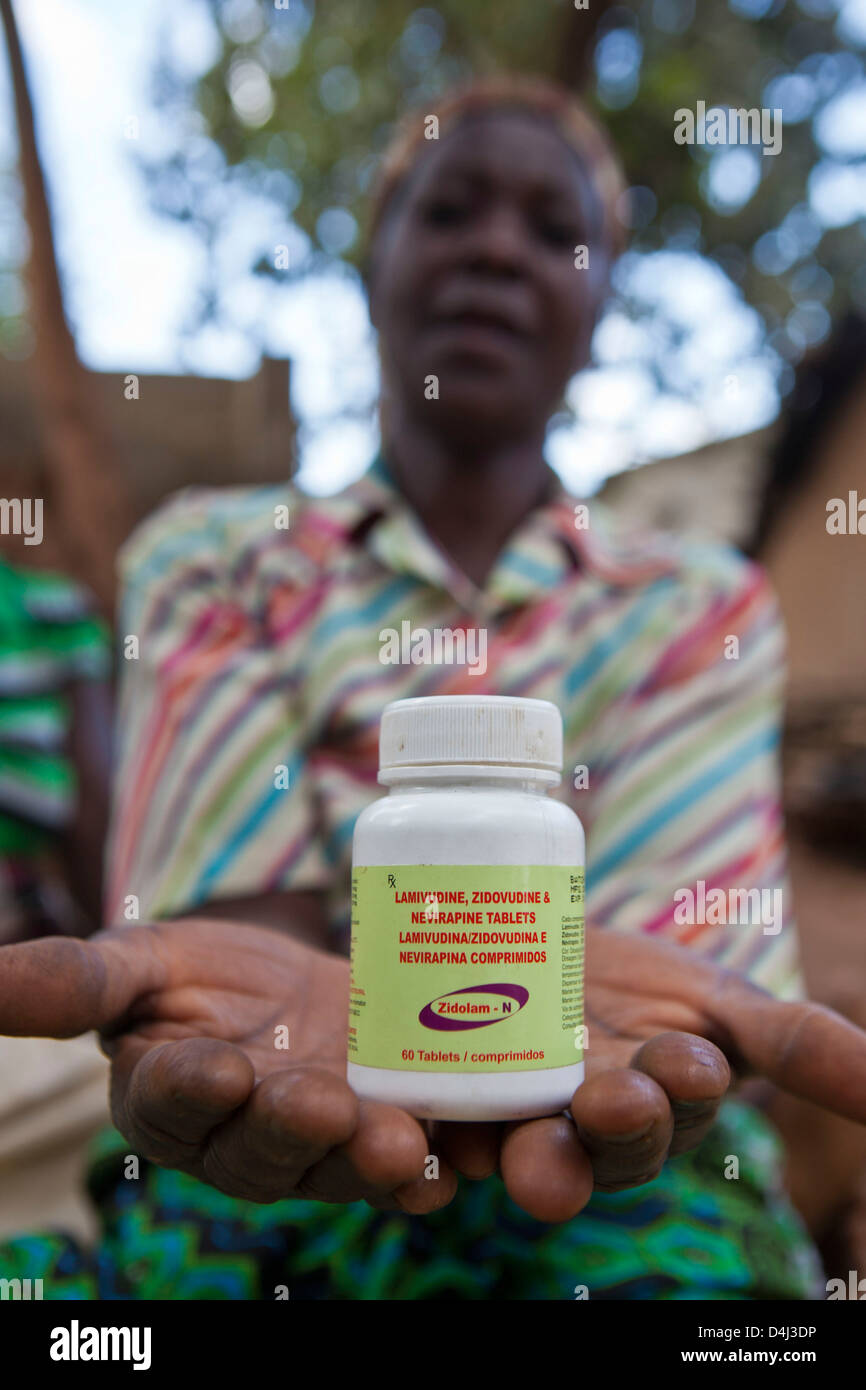 African woman holds her antiretroviral medication in her hands ...