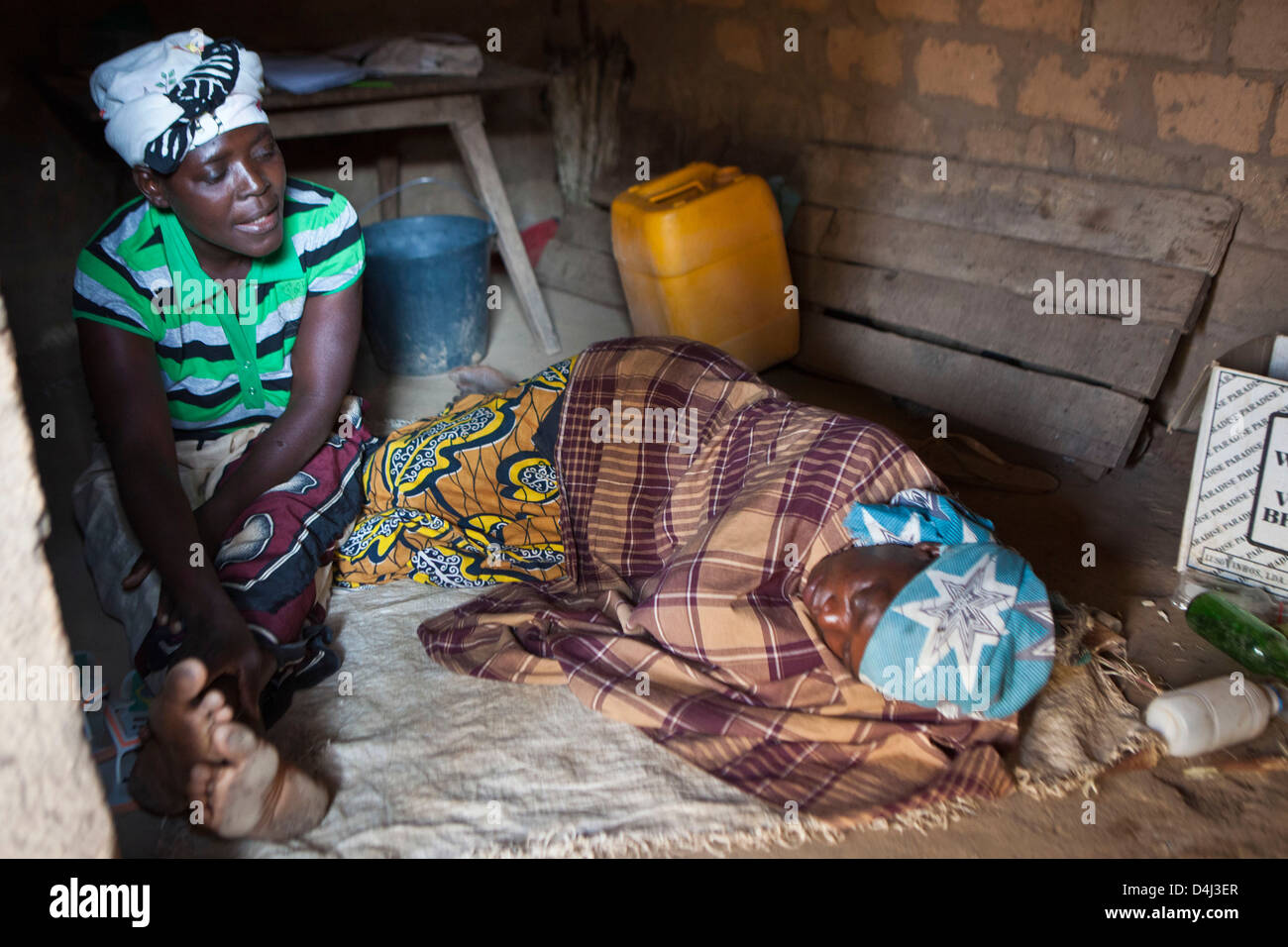 African woman at home in her village, Mozambique. She is in poor health ...
