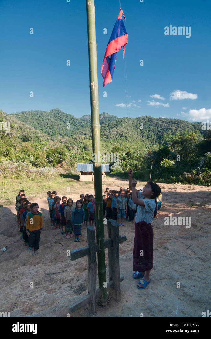 Akha girl performing flag ceremony at a rural school in Phongsaly, Laos ...