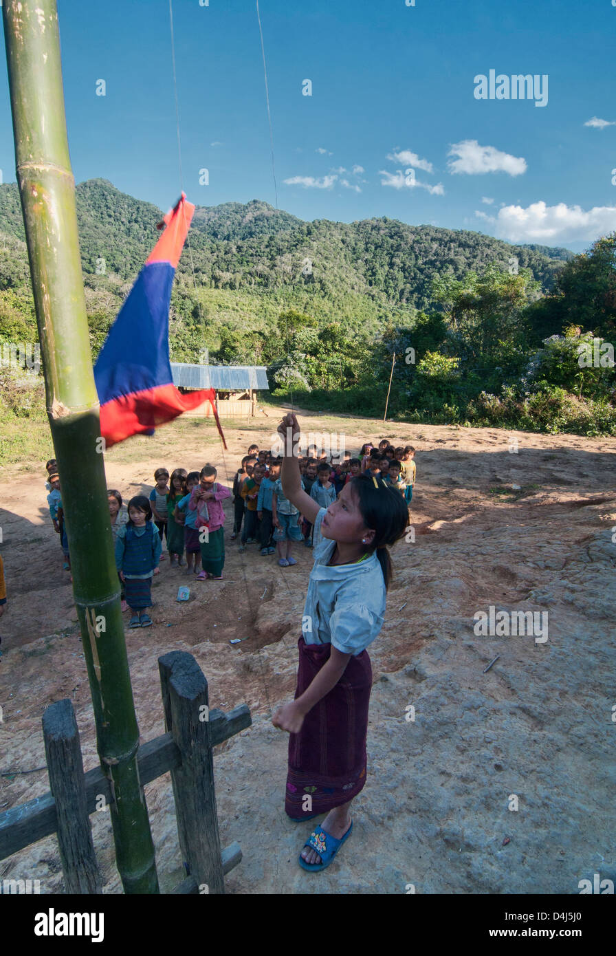 Akha girl performing flag ceremony at a rural school in Phongsaly, Laos ...