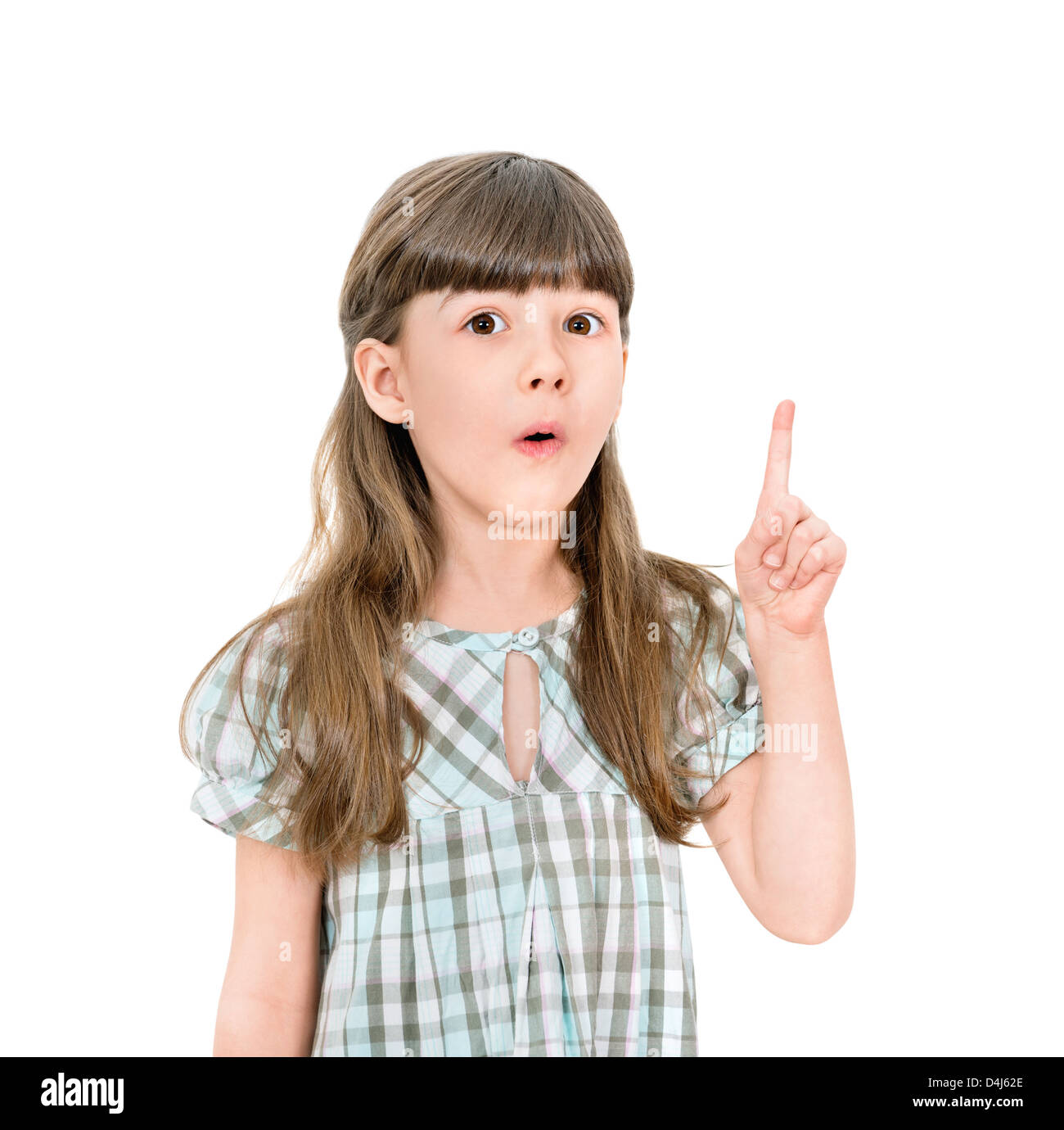 Clever little girl with a bright idea pointing upwards with her finger ...