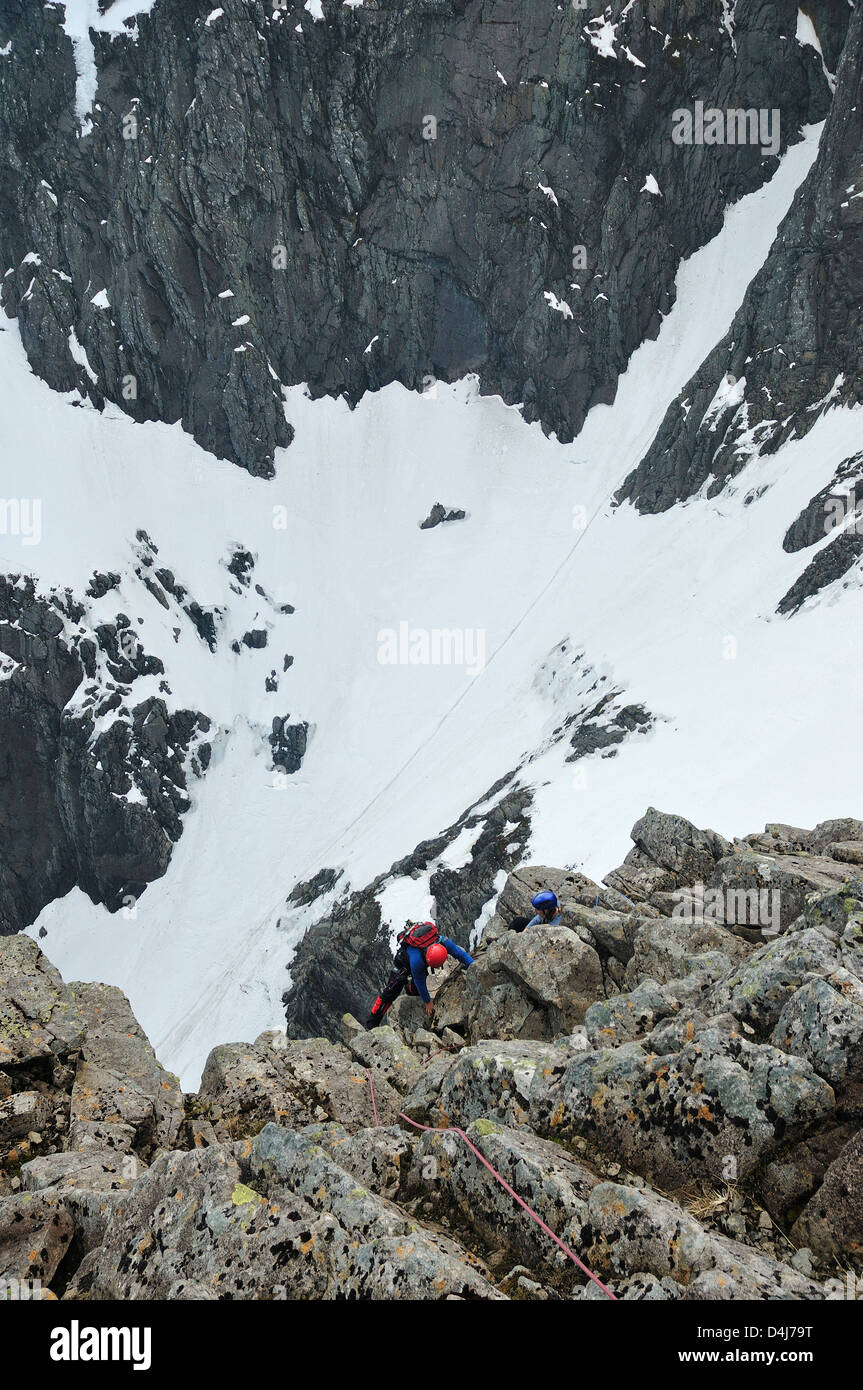 Two climbers on Tower Ridge, Ben Nevis, with a huge drop below into ...