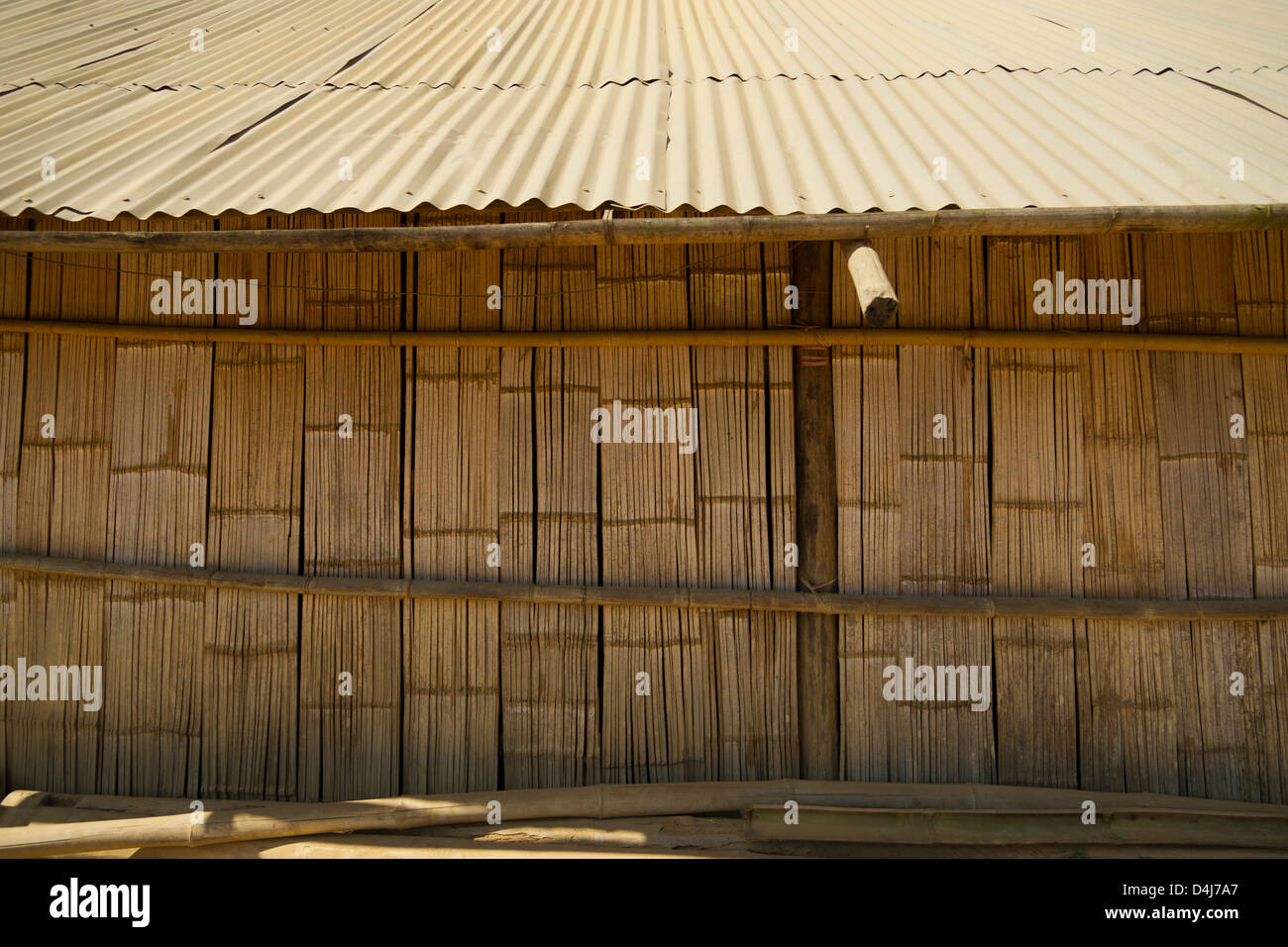 A bamboo building and corrugated tin roof display rhythmic patterns ...