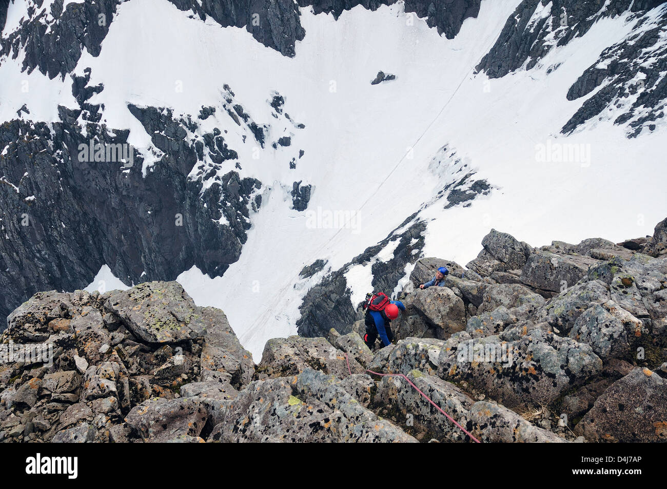 Two climbers on Tower Ridge, Ben Nevis, with a huge drop below into ...