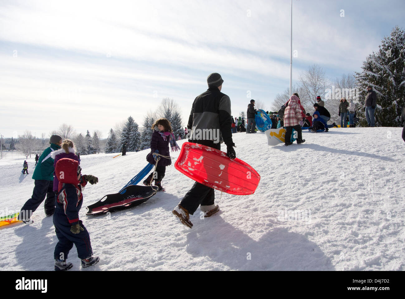 Winter fun, children sledding on hillside Stock Photo - Alamy