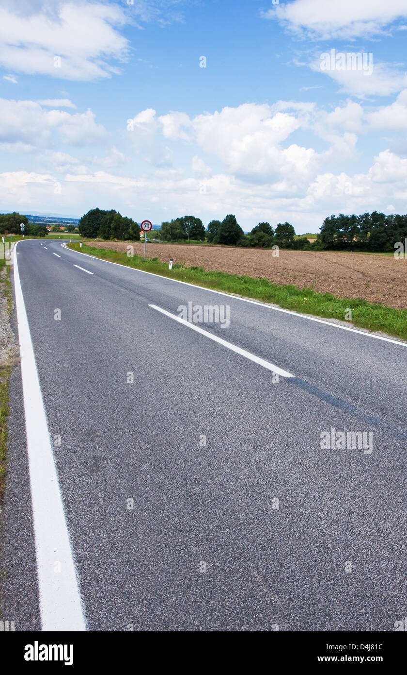 Straight asphalt road leading into the distance Stock Photo - Alamy