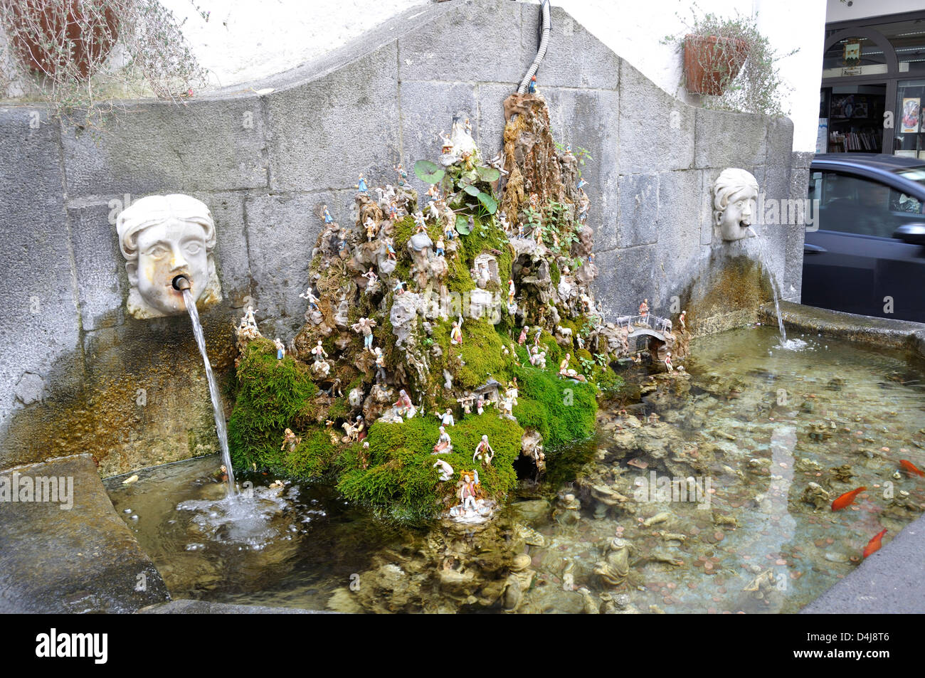 A water feature in Amalfi, Italy, decorated with small figures both ...