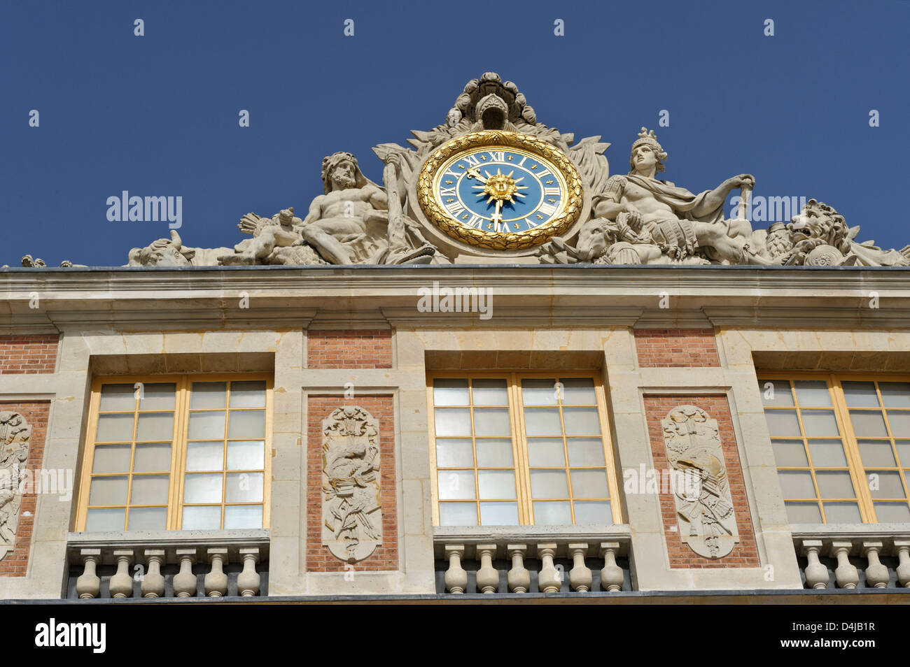 Clock and statues on the facade of Versailles Palace, Versailles ...